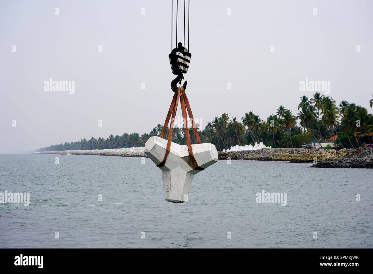 A tetrapod is lowered to the sea as part of the construction for a new ...
