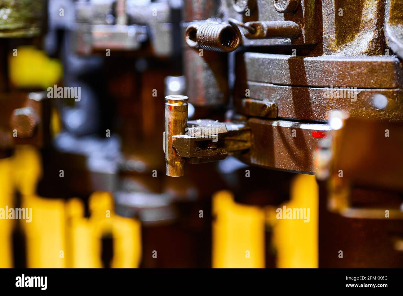 Clamp with brass bullet casing at ammo production plant Stock Photo - Alamy