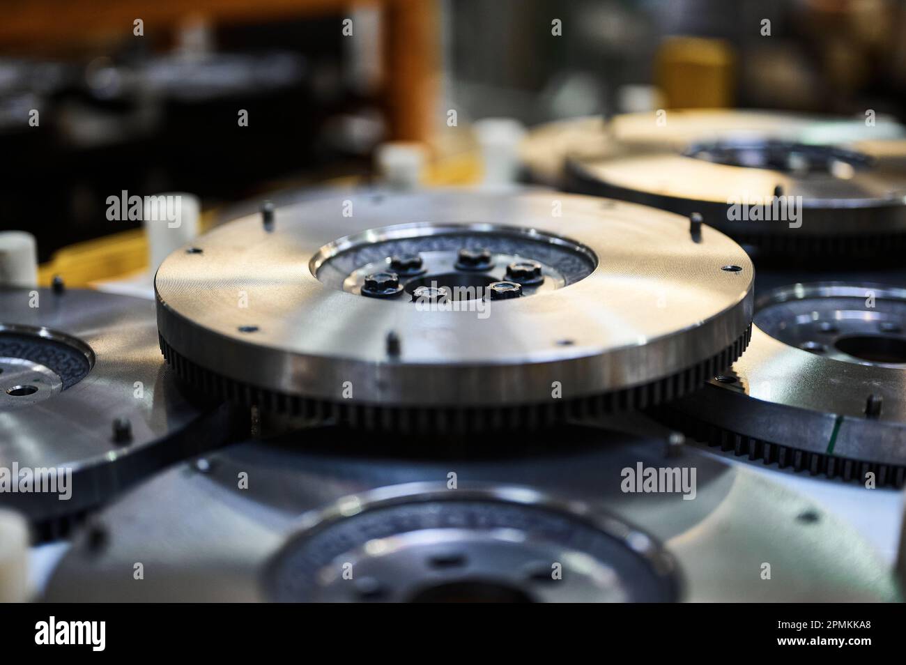 Car engine flywheels on shelf at auto production factory Stock Photo ...