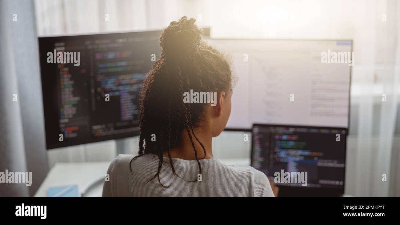 Professional female programmer working on new project on computer at ...