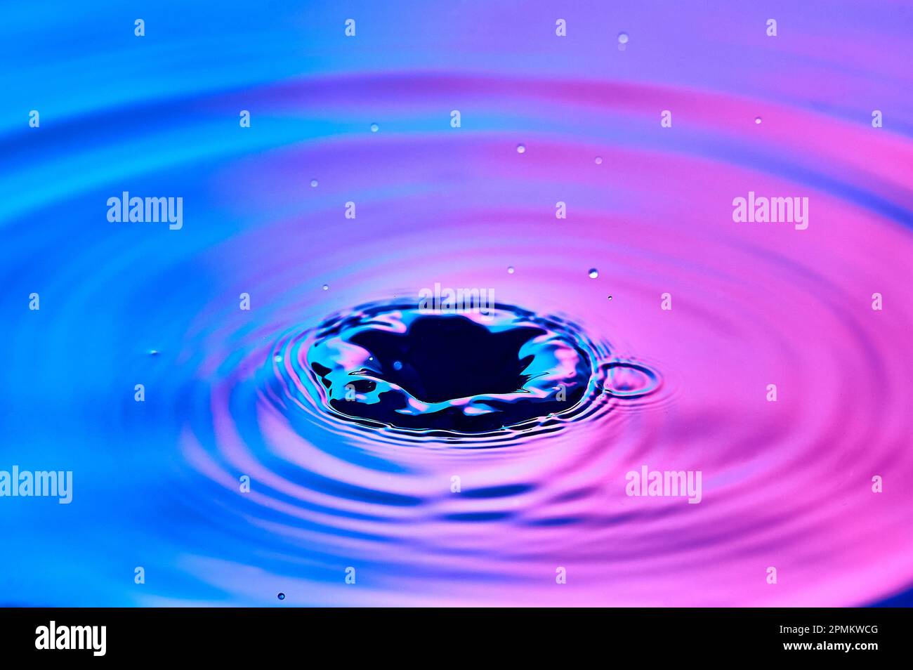a drop of water falling into the water and creating waves Stock Photo ...