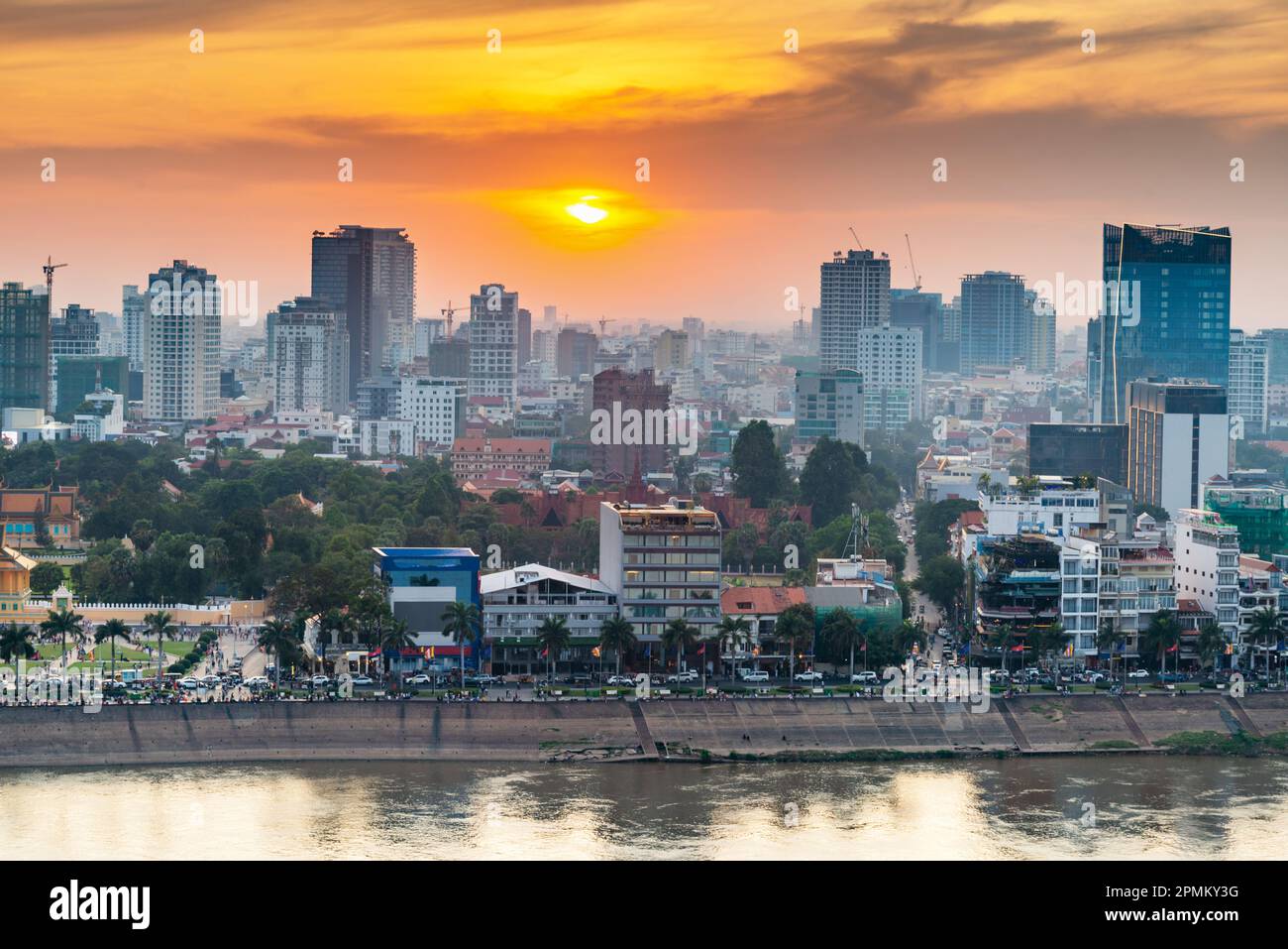 The golden sun hangs low over Cambodia's capital city,it's busy ...