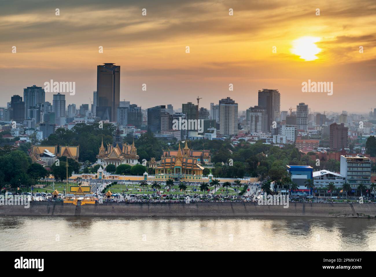 The golden sun hangs over Cambodia's capital city and it's busy ...