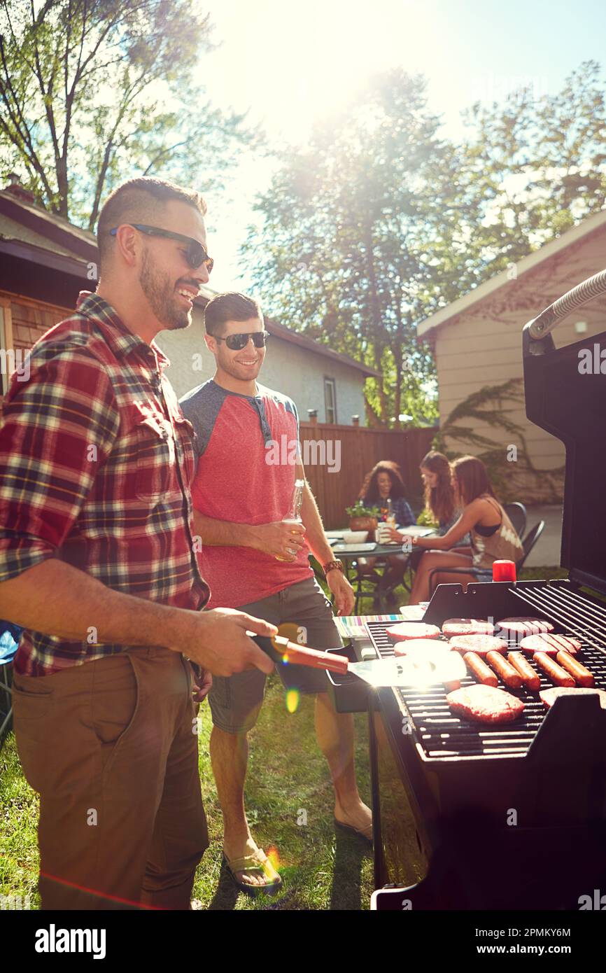Happy friends having bbq party hi-res stock photography and images - Alamy