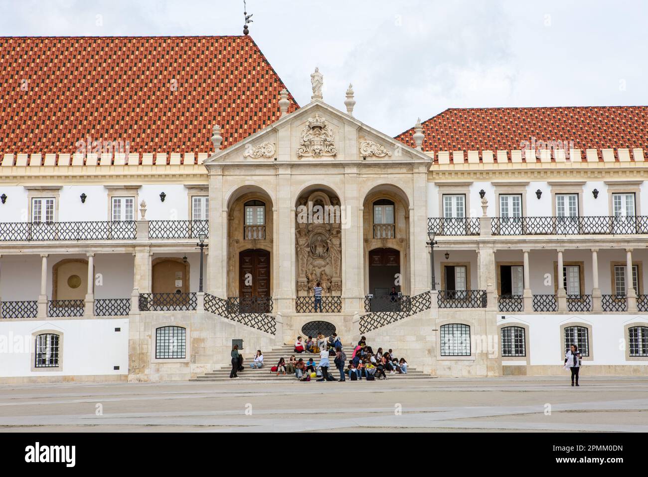 Coimbra, Portugal. 31st Mar, 2023. Visitors sit on the steps of the ...