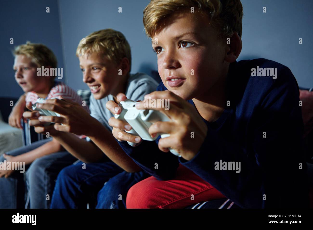 Hes got his game face on. young boys playing video games Stock Photo ...