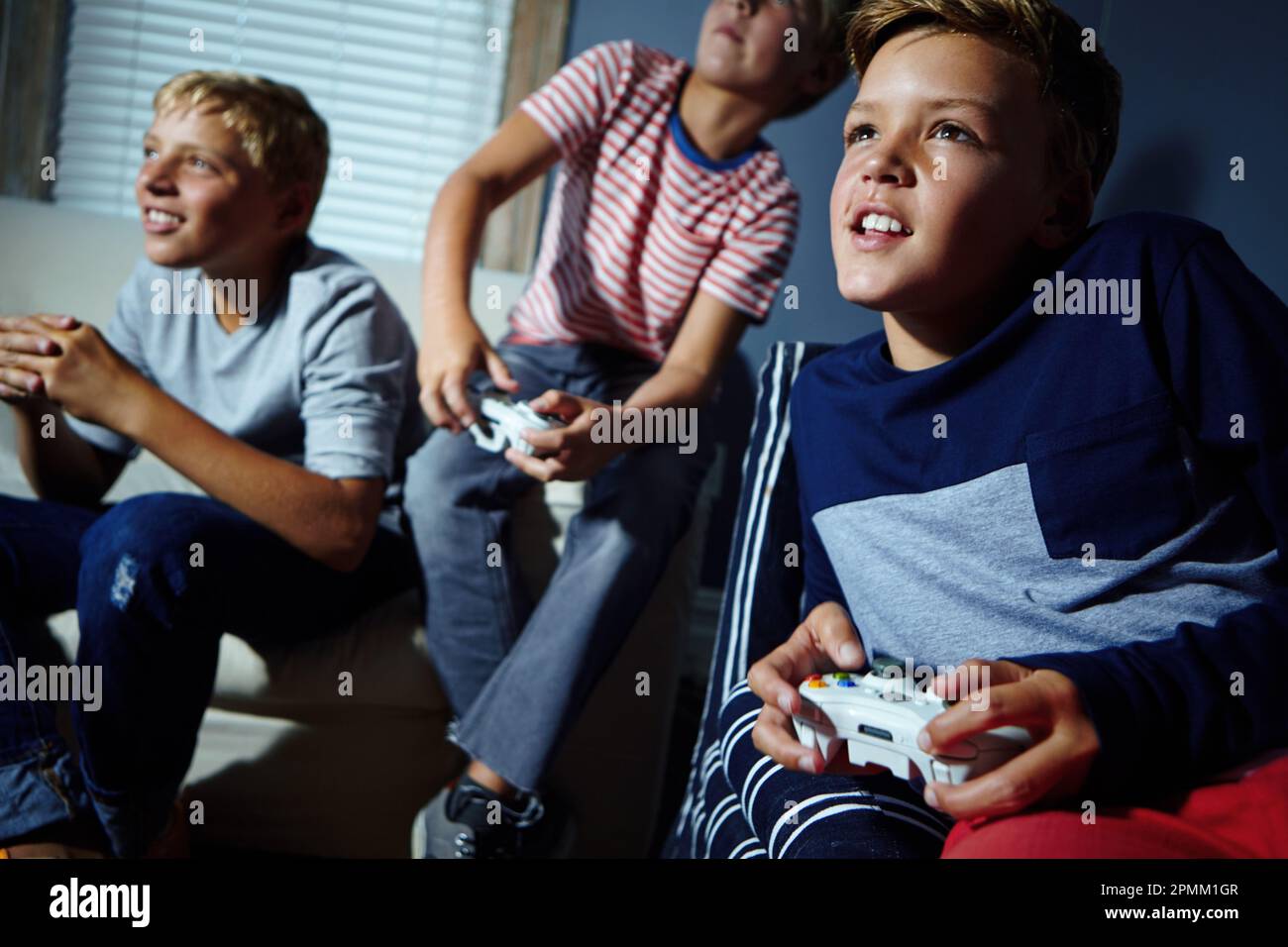 We could play all night. young boys playing video games Stock Photo - Alamy