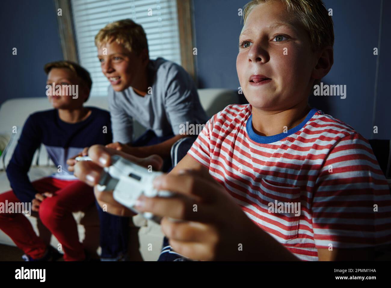 Hes a master of the controller. young boys playing video games Stock ...