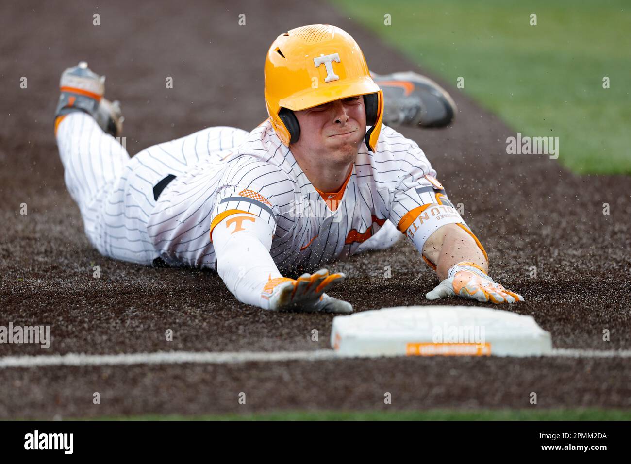 Tennessee Volunteers catcher Charlie Taylor (14) slides into third base ...