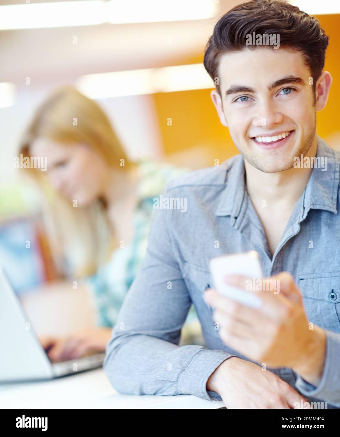 The bond between a man and his cellphone. Attractive male student ...