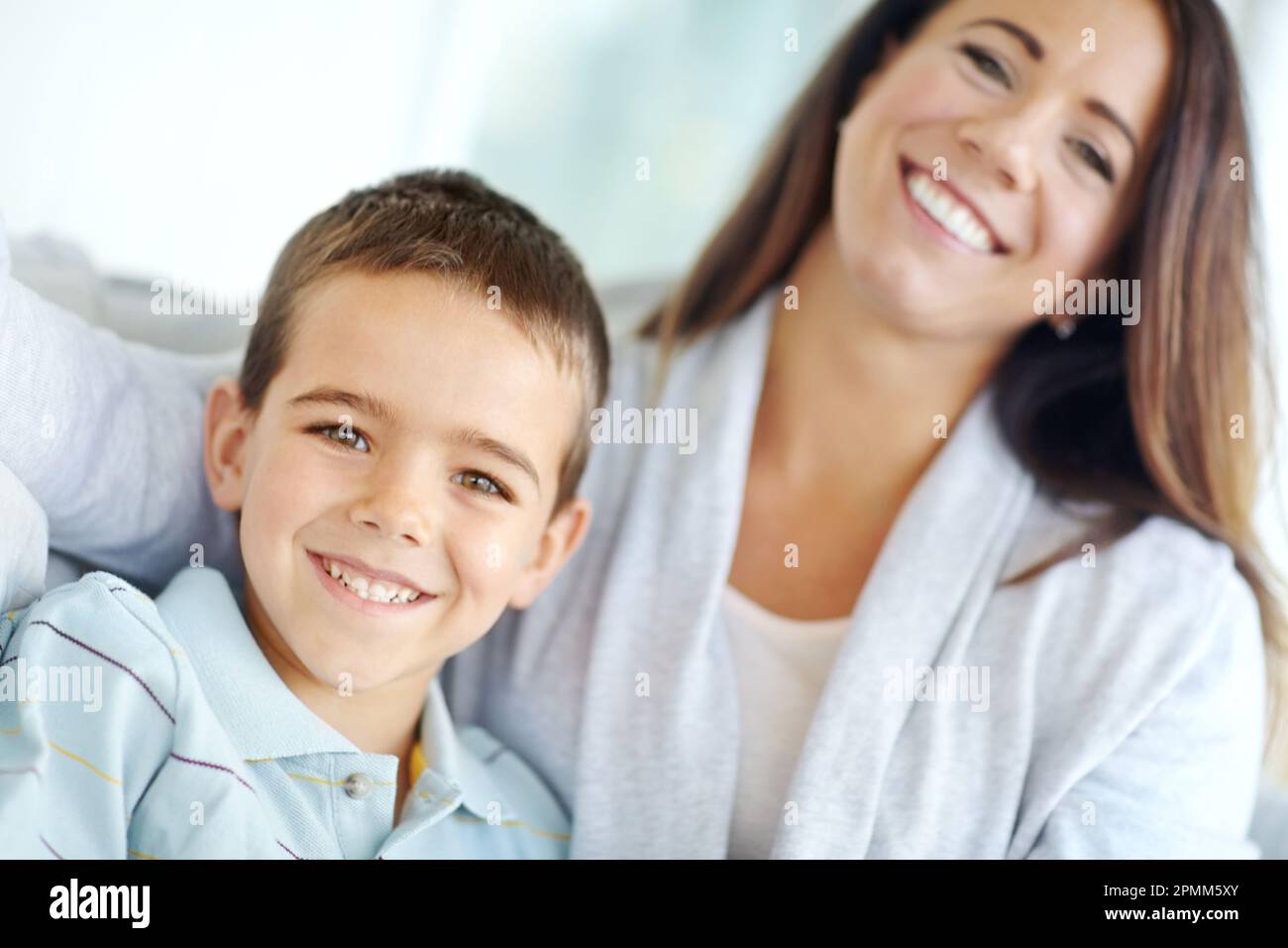 Spending time with mommy. Image of a mother and son smiling at the ...
