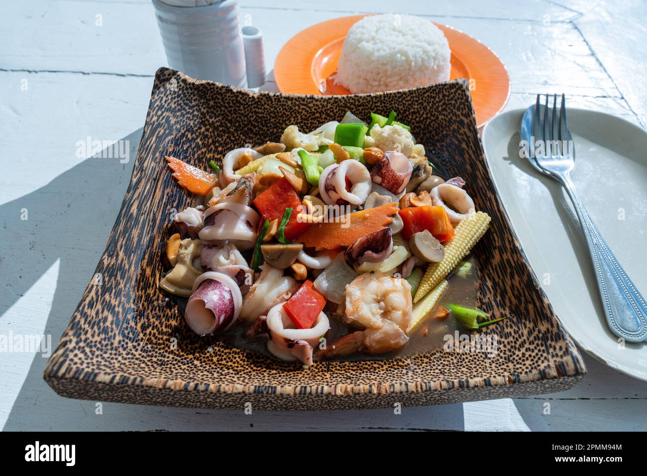 Stir fried cashew nut with seafood and vegetable in plate, close up ...
