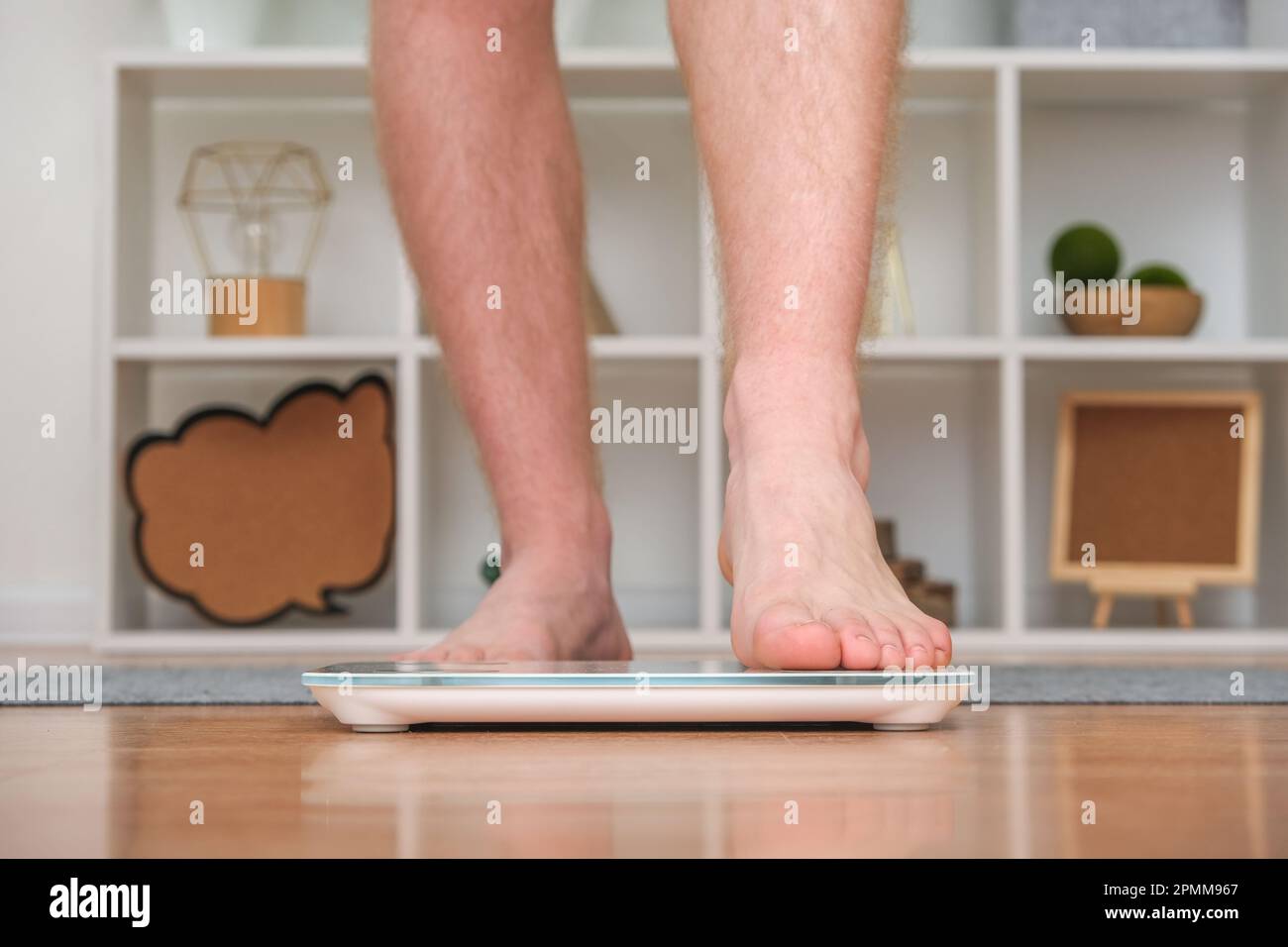 Man weighing himself on the scales hi-res stock photography and images ...