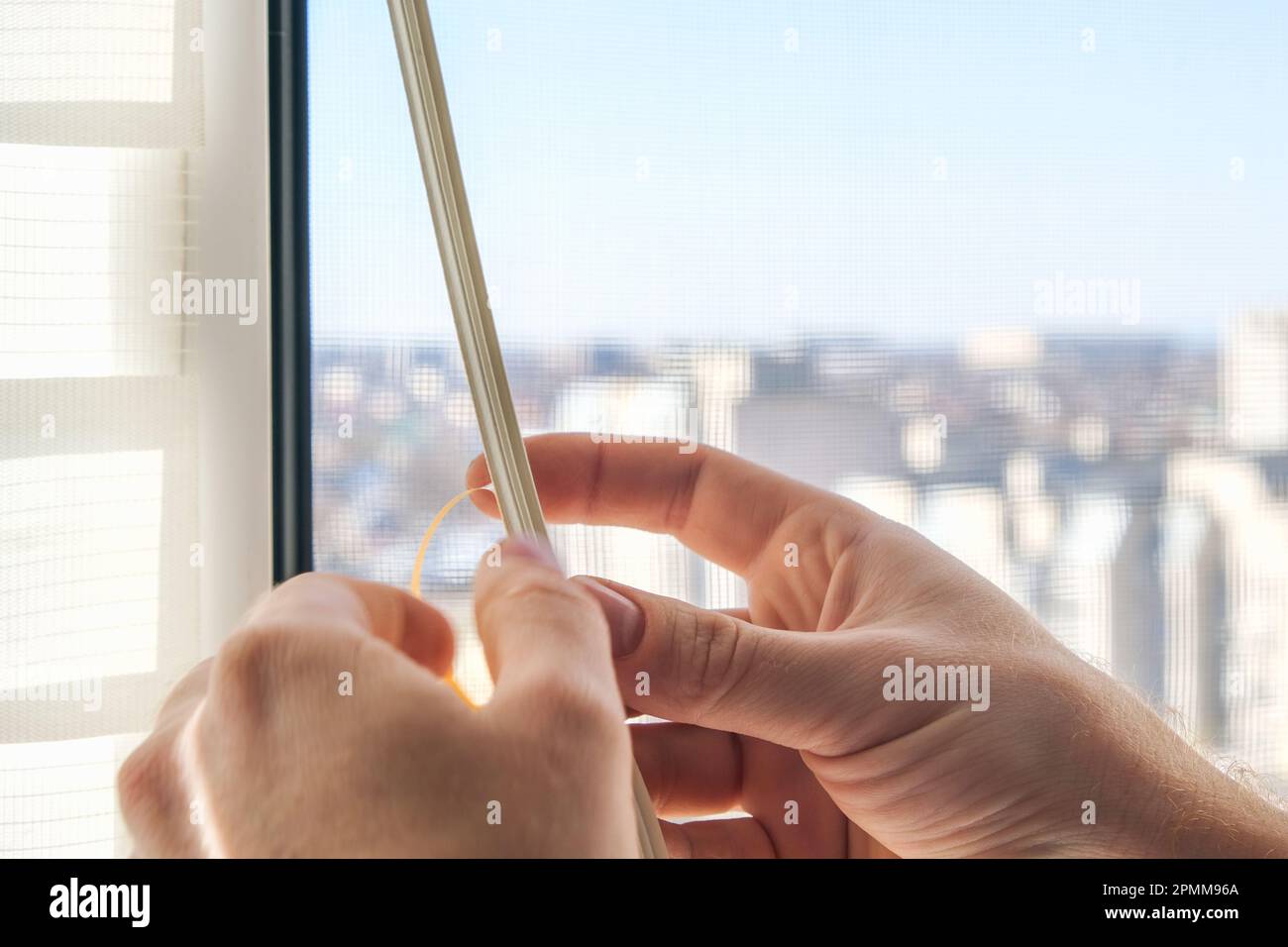 The man wipes the window frame with a degreaser and glues a sealing ...