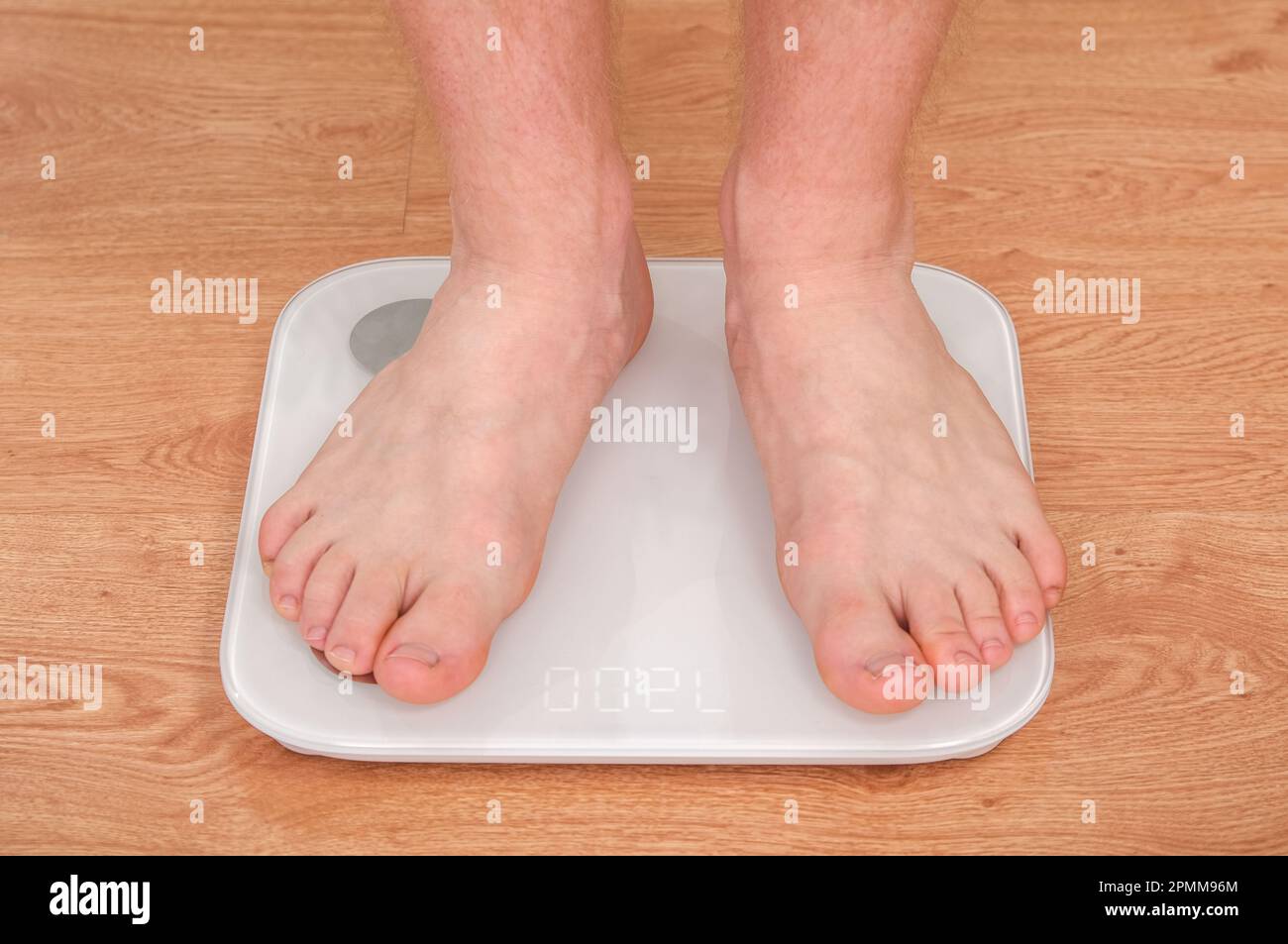 Man weighing himself on the scales hi-res stock photography and images ...