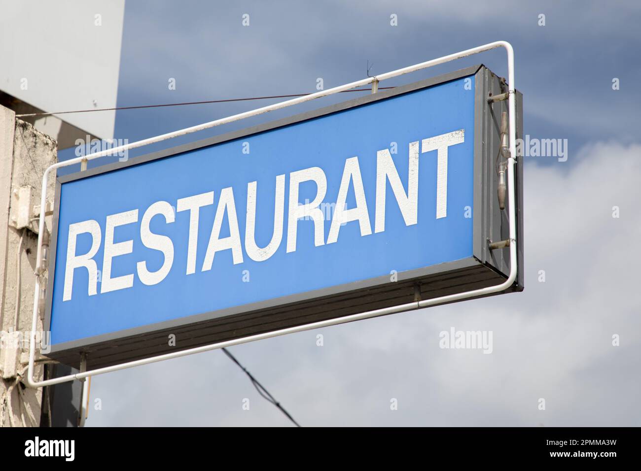 vintage restaurant sign on building facade simple basic text on blue ...