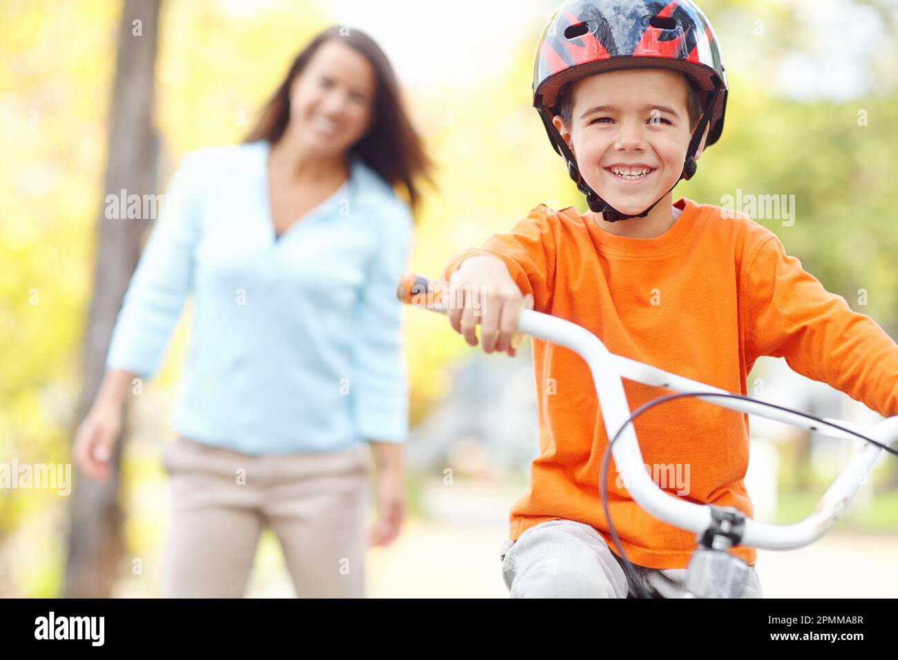 Im riding a bicycle for the first time. A single mother watching her ...