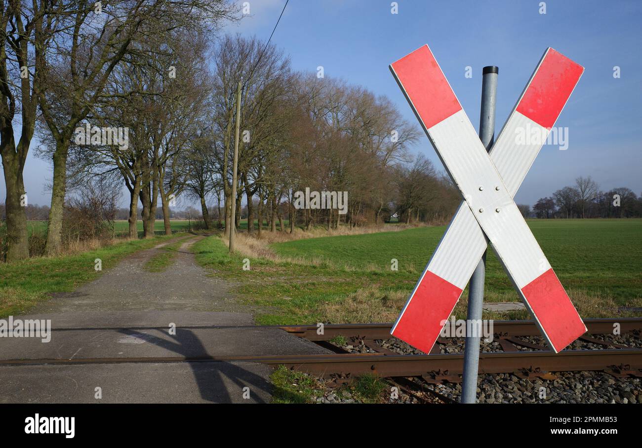 A rural road crosses a railway. An unguarded crossing in Germany Stock ...