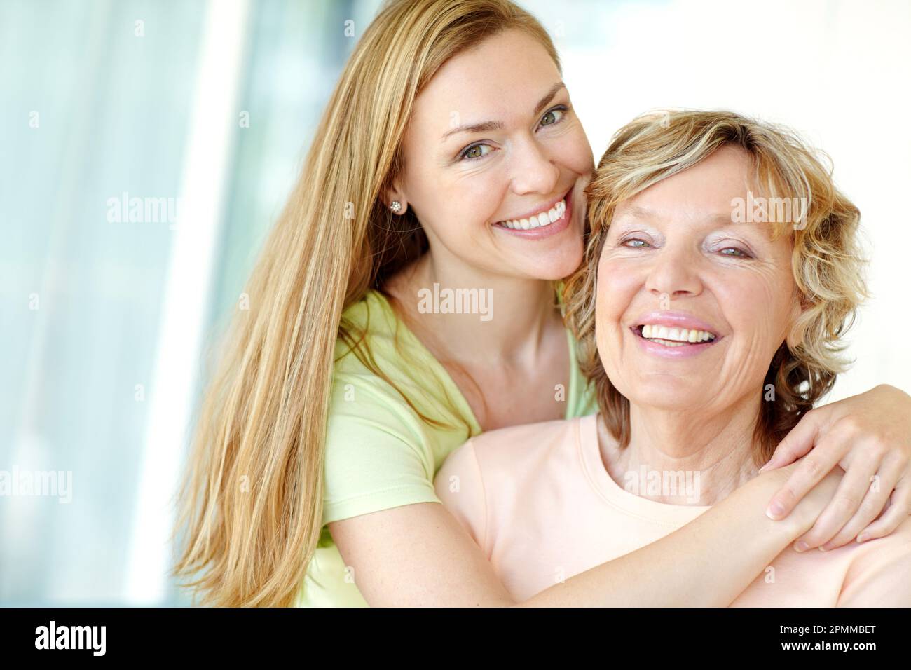 I love my mom. A beautiful woman hugging her mother affectionately ...