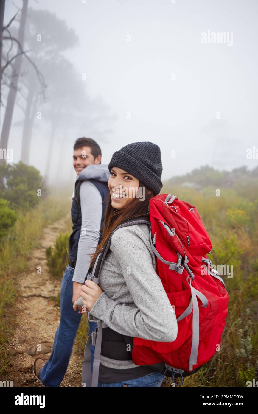 Setting out on the trail. Portrait of a beautiful young woman hiking ...