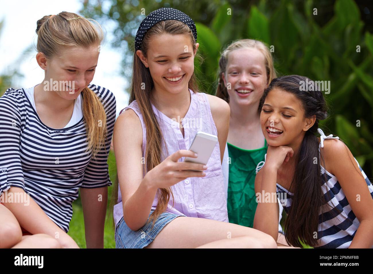 Just being real with each other. A young girl showing her friends ...