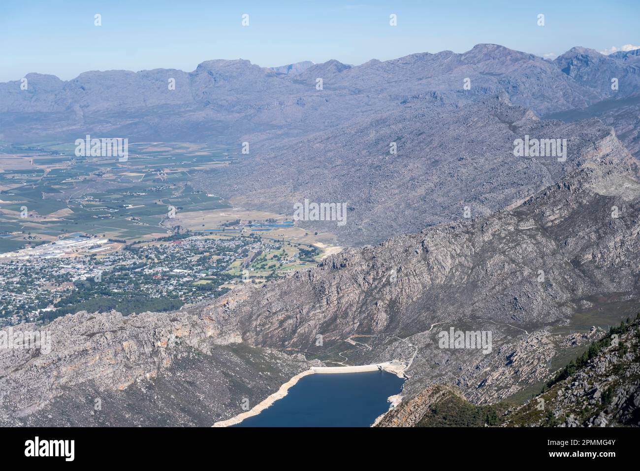 aerial landscape, from a glider, with dam and lake among rocky slopes ...