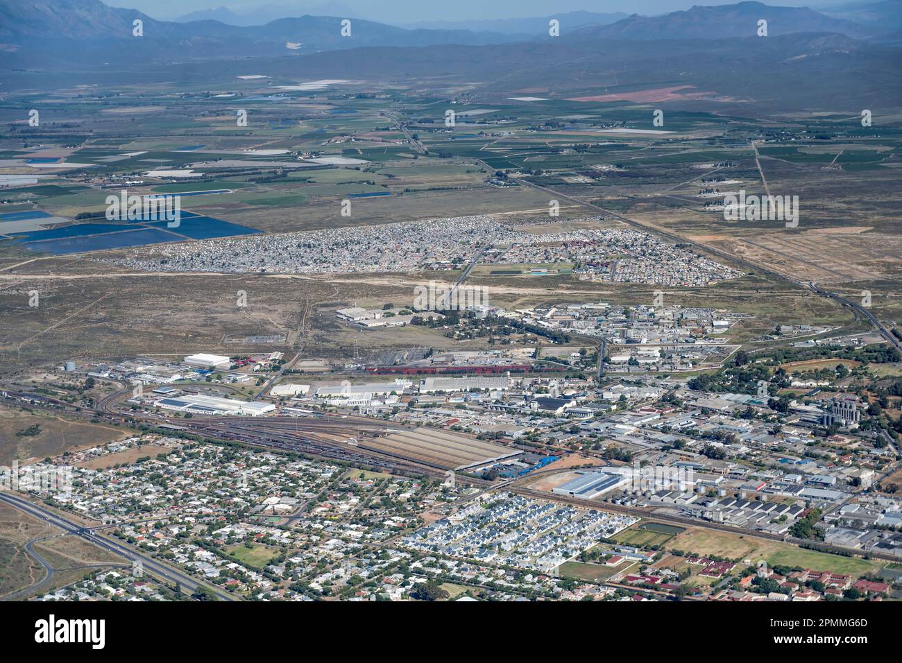 aerial landscape, from a glider, with railway yard, highway and shanty ...
