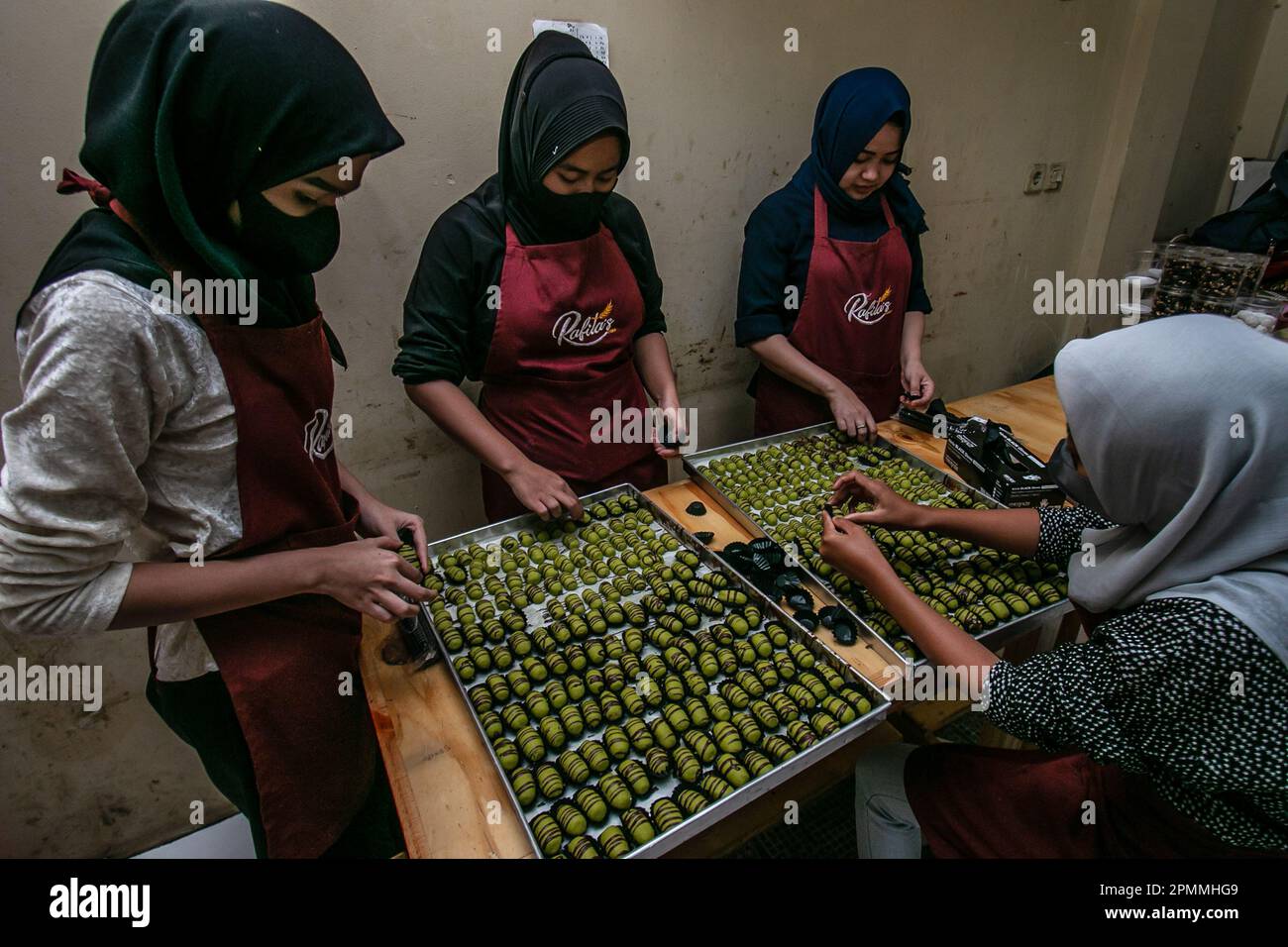 Workers produce pastries at the Rafita's Cake outlet, Bogor City ...