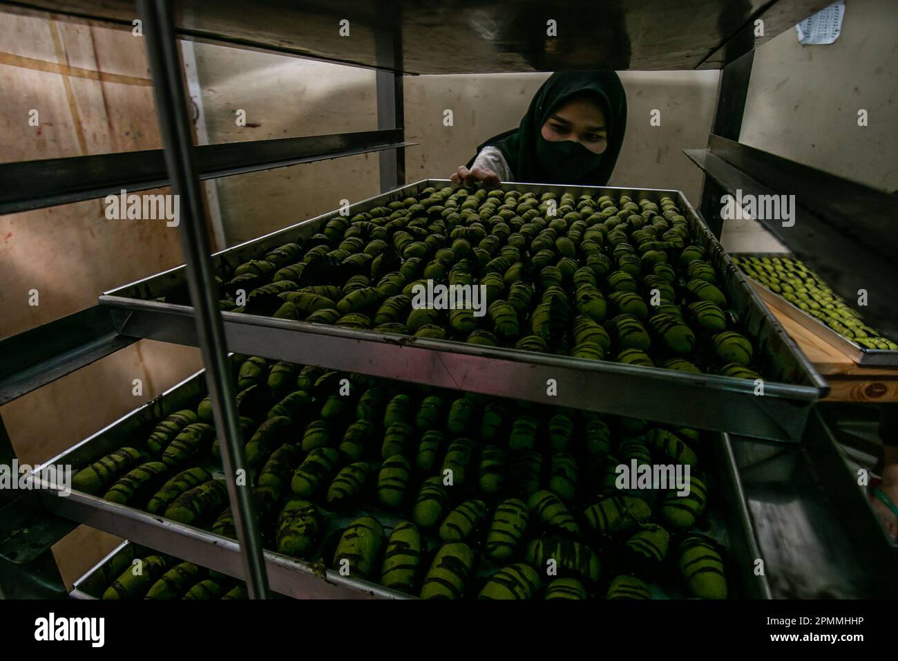 Workers produce pastries at the Rafita's Cake outlet, Bogor City ...