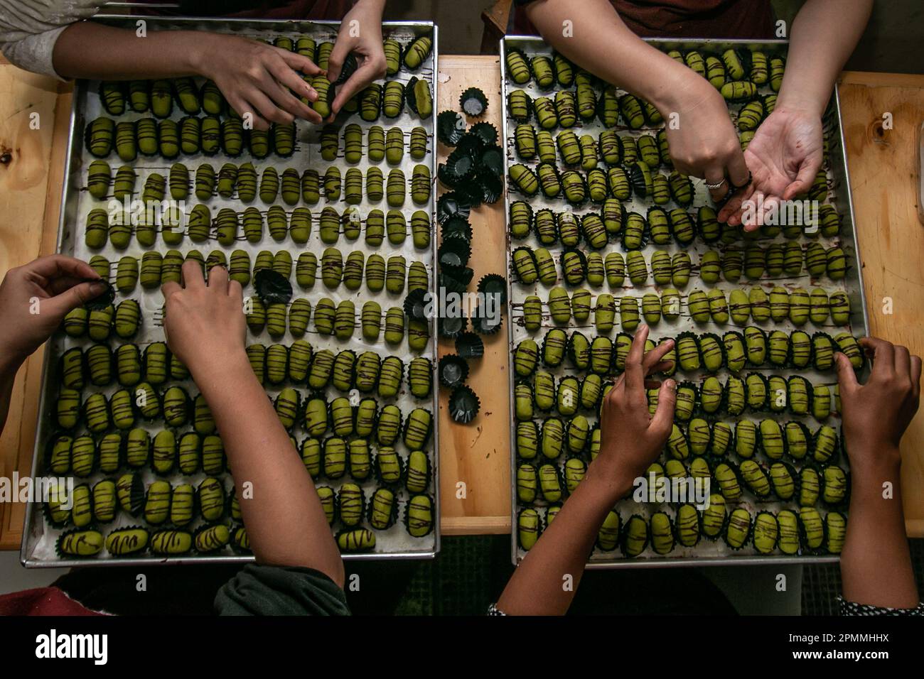 Workers produce pastries at the Rafita's Cake outlet, Bogor City ...