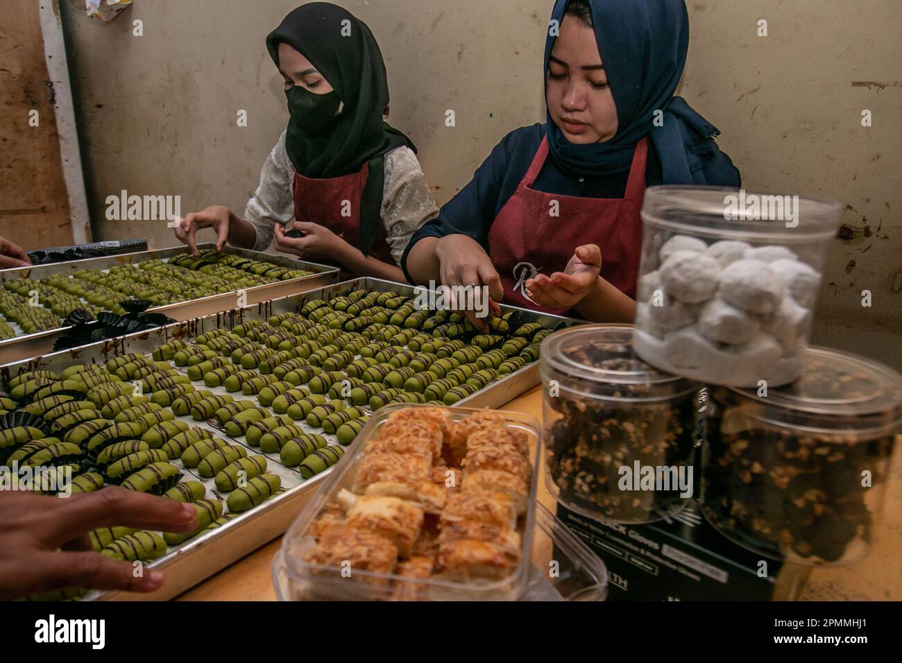 Workers produce pastries at the Rafita's Cake outlet, Bogor City ...
