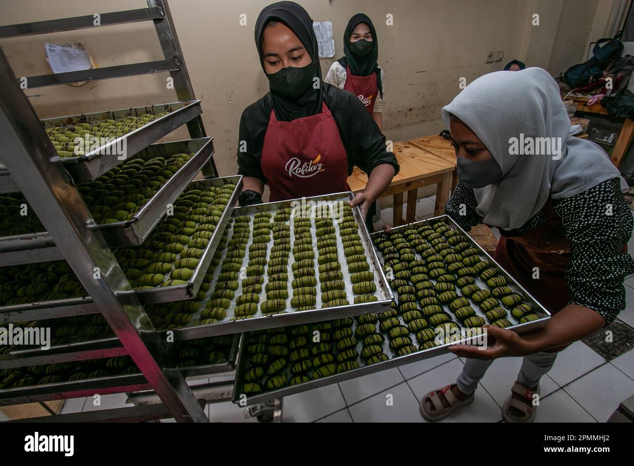 Workers produce pastries at the Rafita's Cake outlet, Bogor City ...