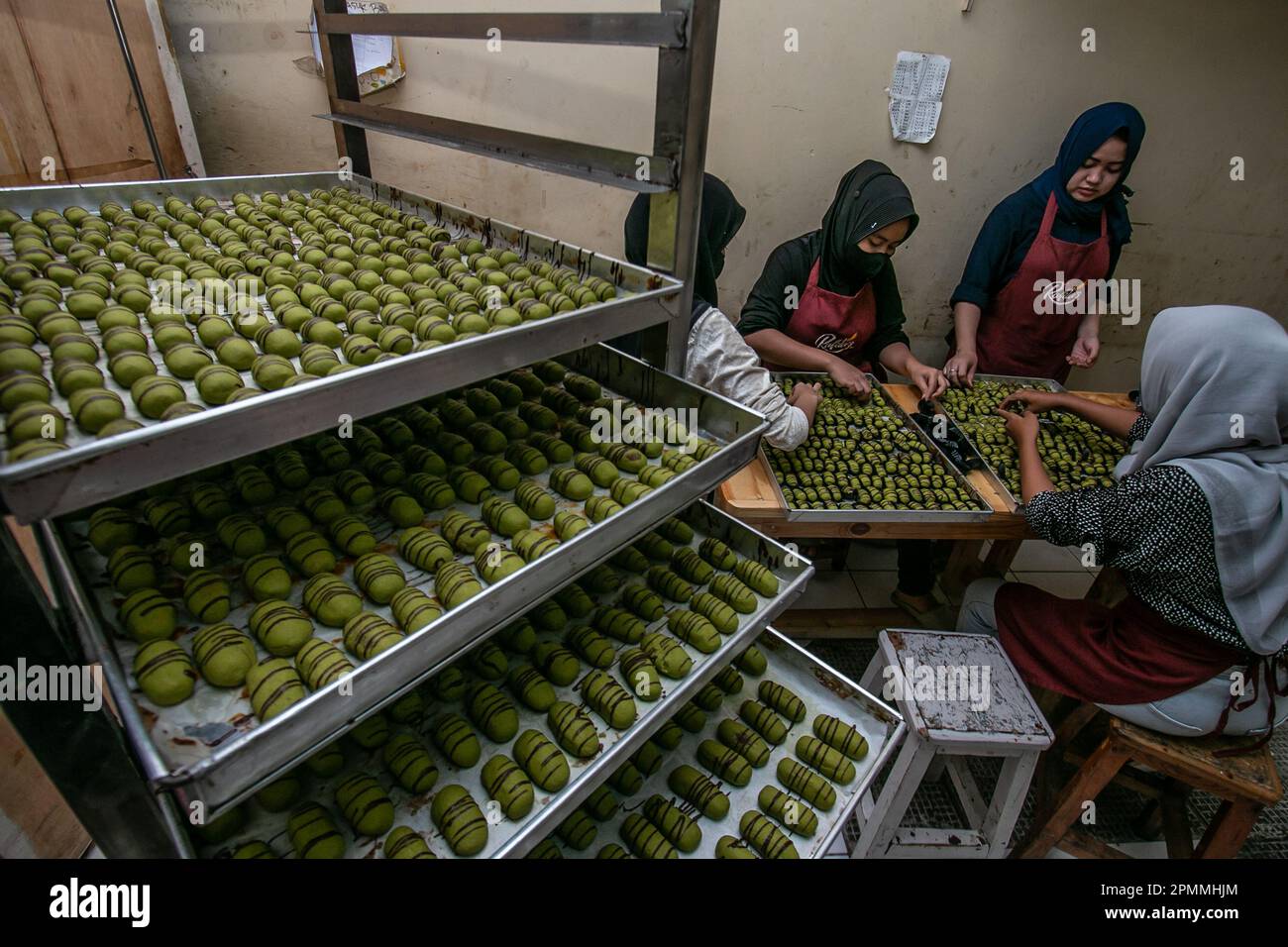 Workers produce pastries at the Rafita's Cake outlet, Bogor City ...