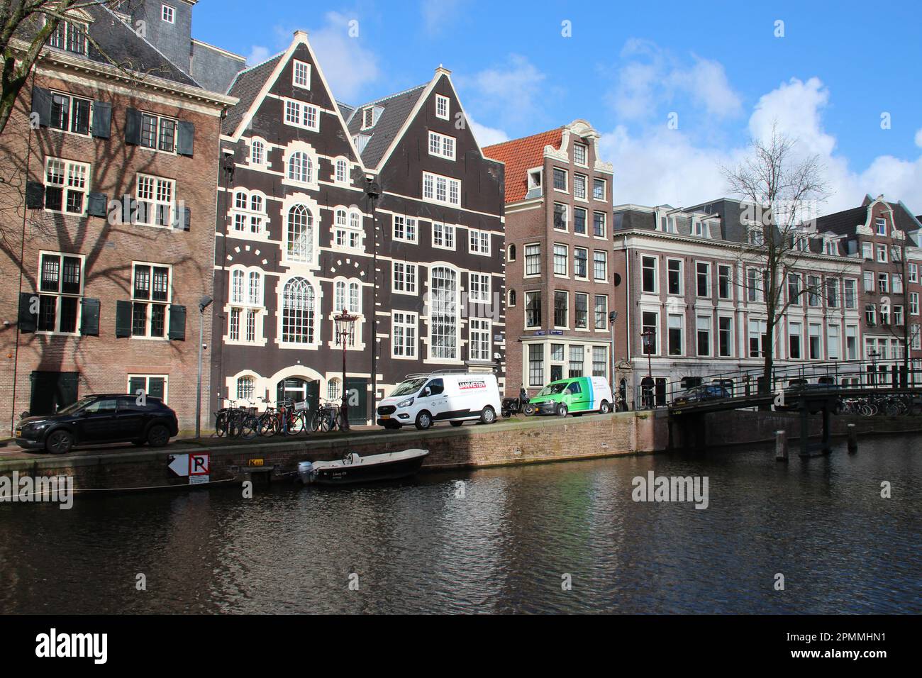 canal, river and old brick houses or flat buildings in amsterdam (the ...