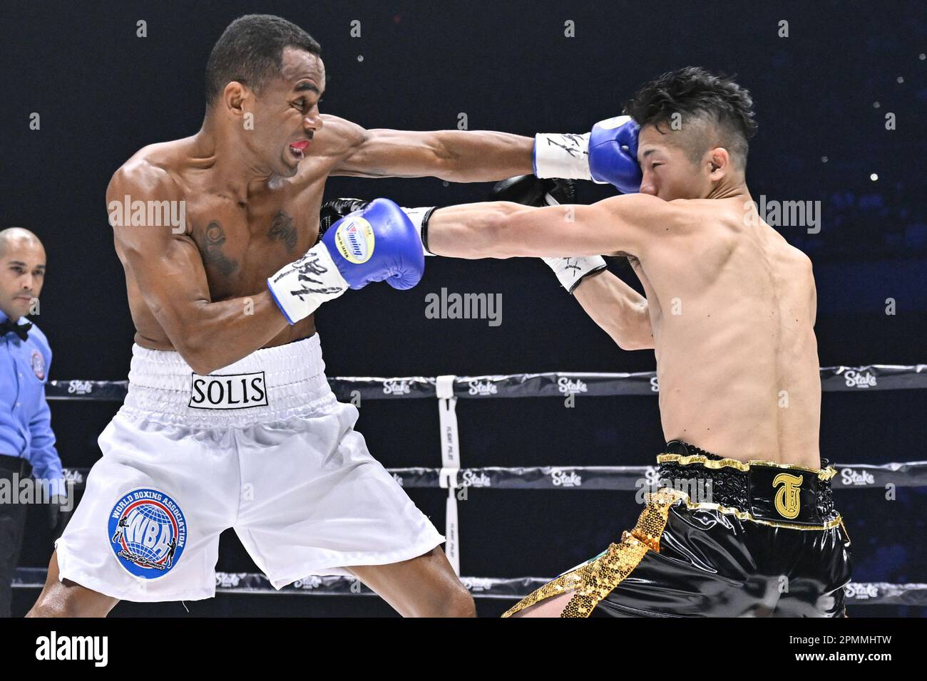 Takuma Inoue (black gloves) of Japan and Liborio Solis (blue gloves) of Venezuela compete during ...