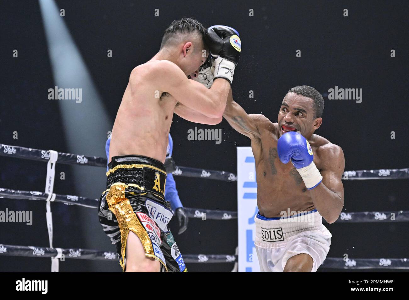 Takuma Inoue (black gloves) of Japan and Liborio Solis (blue gloves) of Venezuela compete during ...