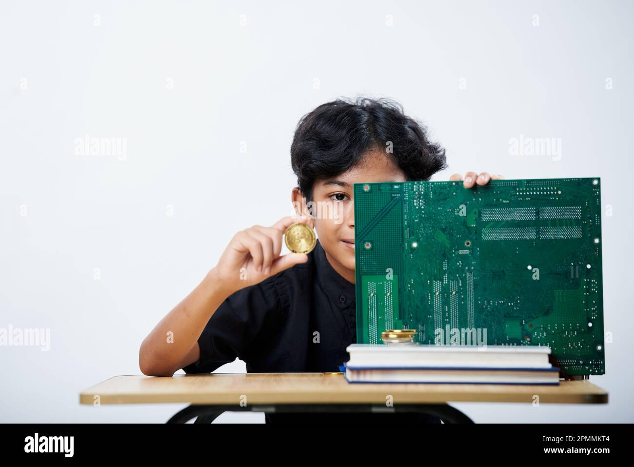 Little boy holding gold Cryptocurrencies coin with isolated white ...