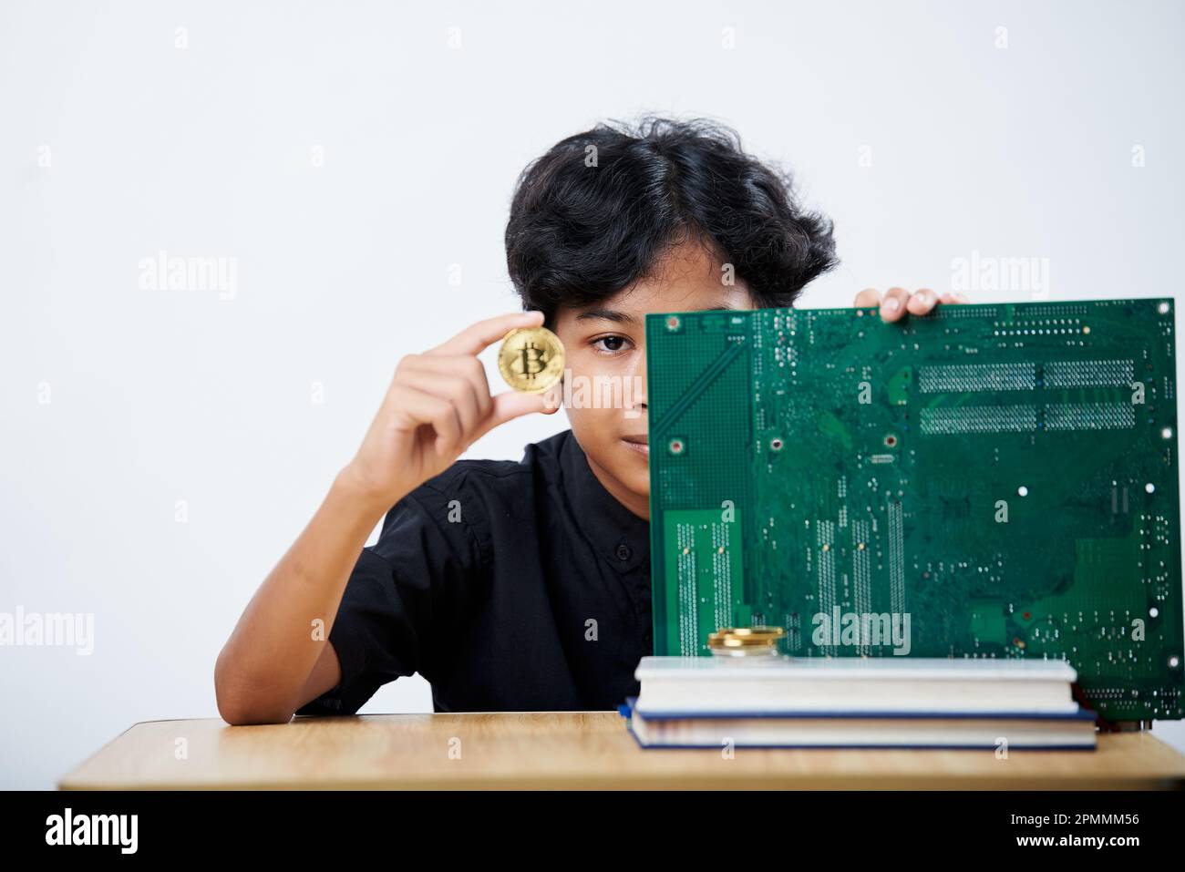 Little boy holding gold Cryptocurrencies coin with isolated white ...
