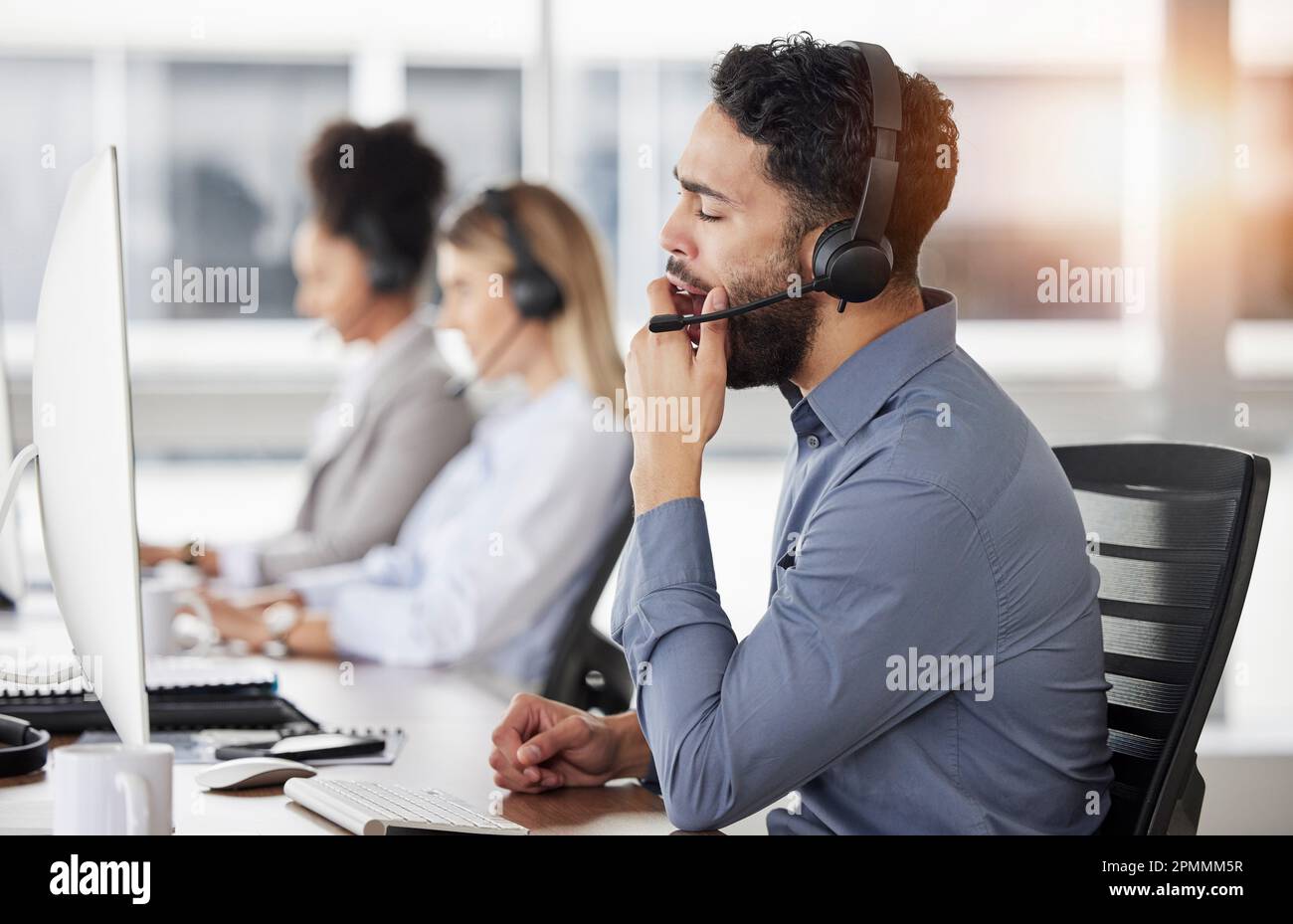 Tired, yawn and man call center agent doing an online consultation on a ...