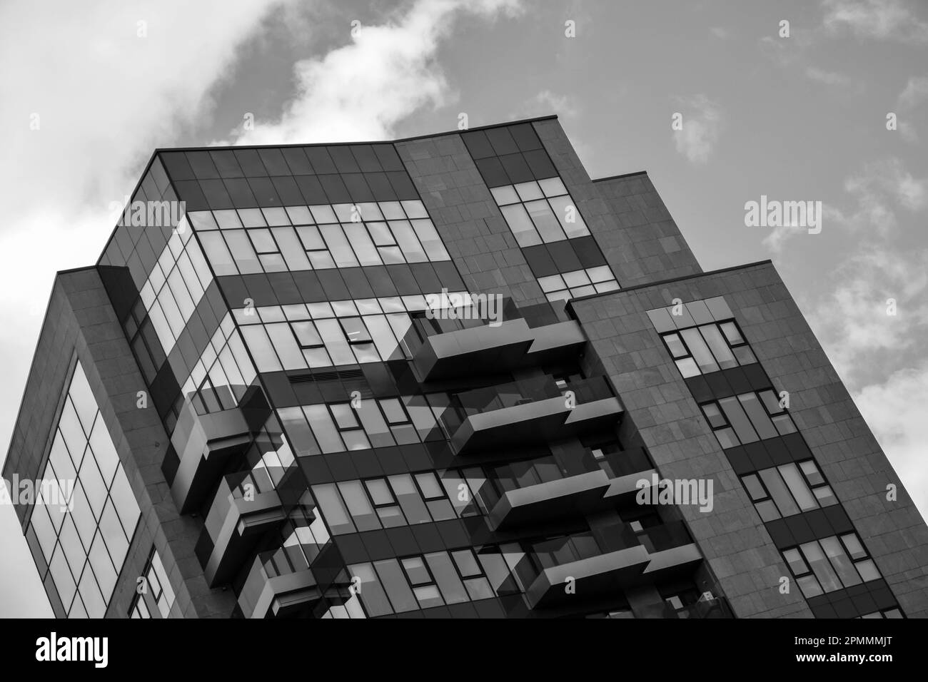Part of building from glass and metal on background of sky with clouds. Construction of modern ...