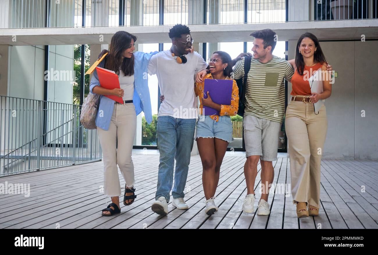 Group of multinational young students walking together in a high school ...