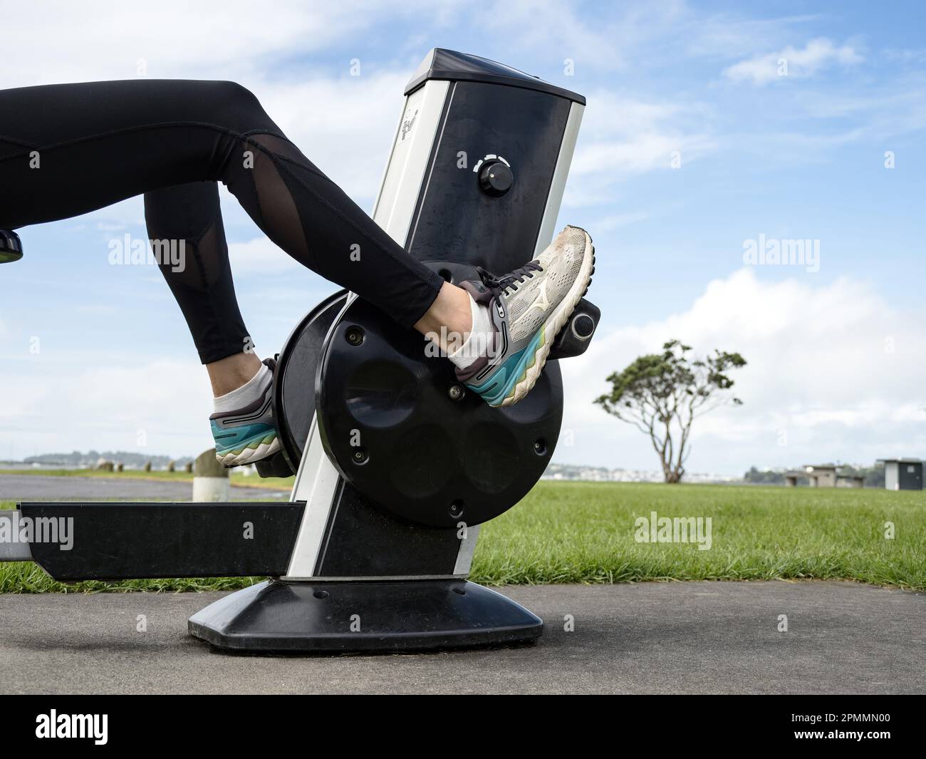 A female using an outdoor stationary spinning exercise bike Stock Photo ...