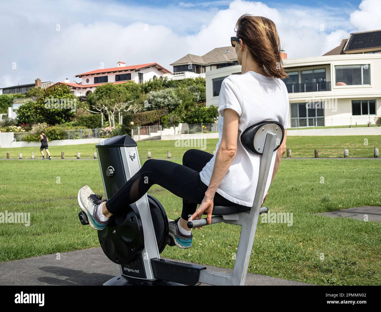 A female using an outdoor stationary spinning exercise bike Stock Photo ...