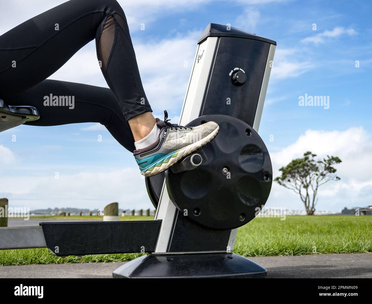A female using an outdoor stationary spinning exercise bike Stock Photo ...
