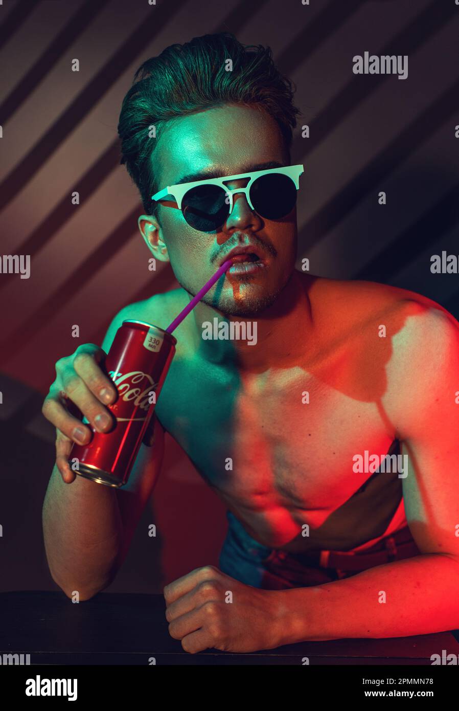 Portrait of a young man holding a can of Coca Cola Stock Photo - Alamy