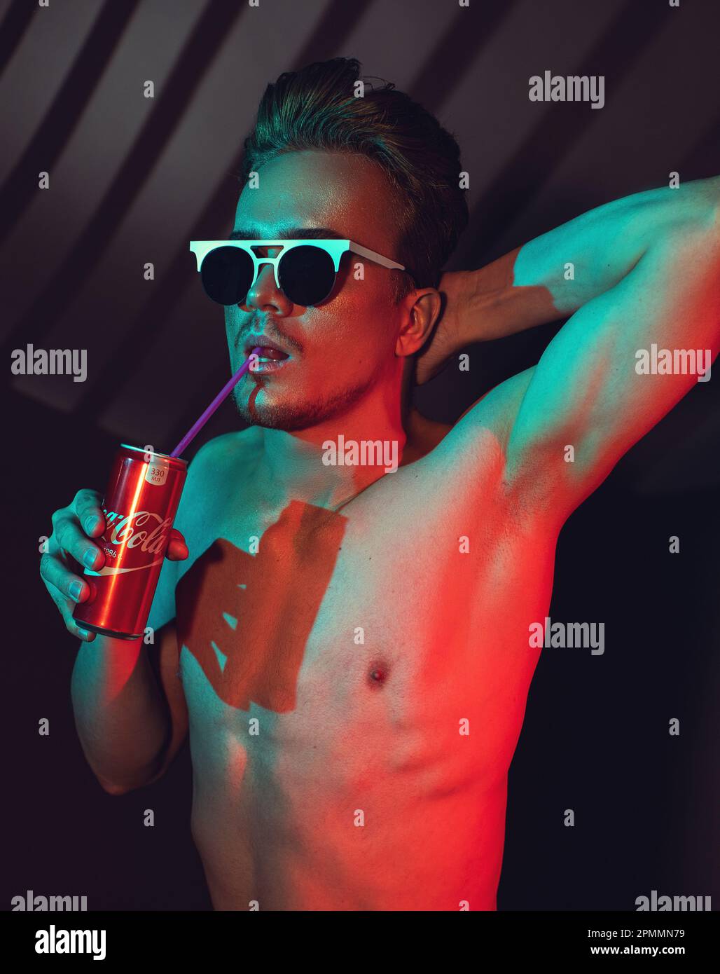 Portrait of a young man holding a can of Coca Cola Stock Photo - Alamy