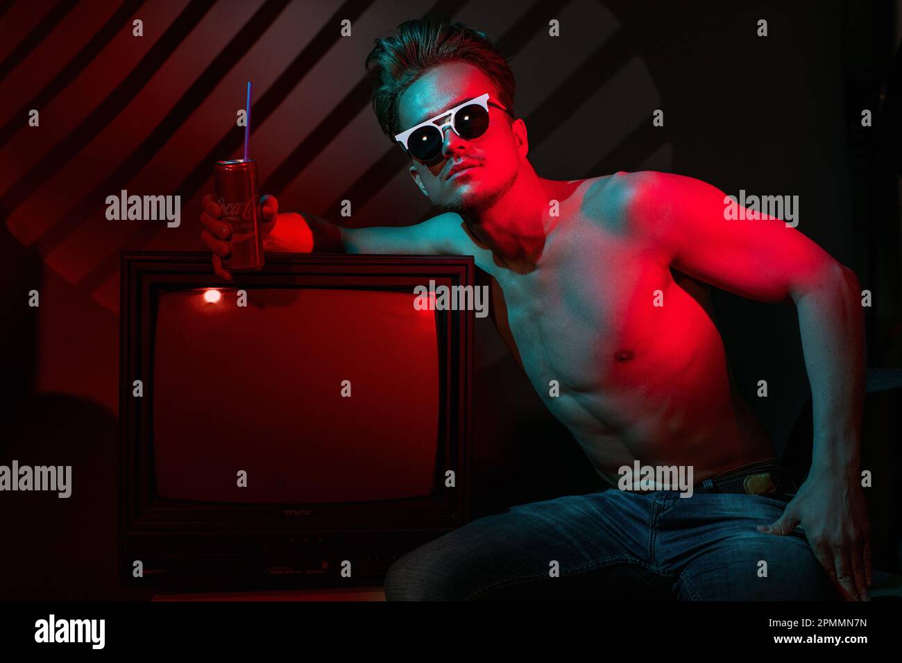 Portrait of a young man holding a can of Coca Cola Stock Photo - Alamy