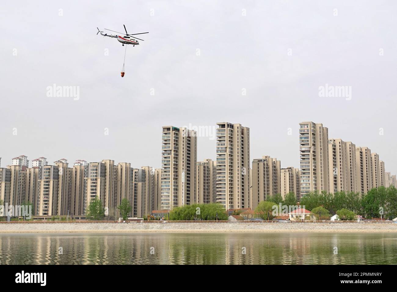 YANTAI, CHINA - APRIL 13, 2023 - A helicopter loading a fire ...