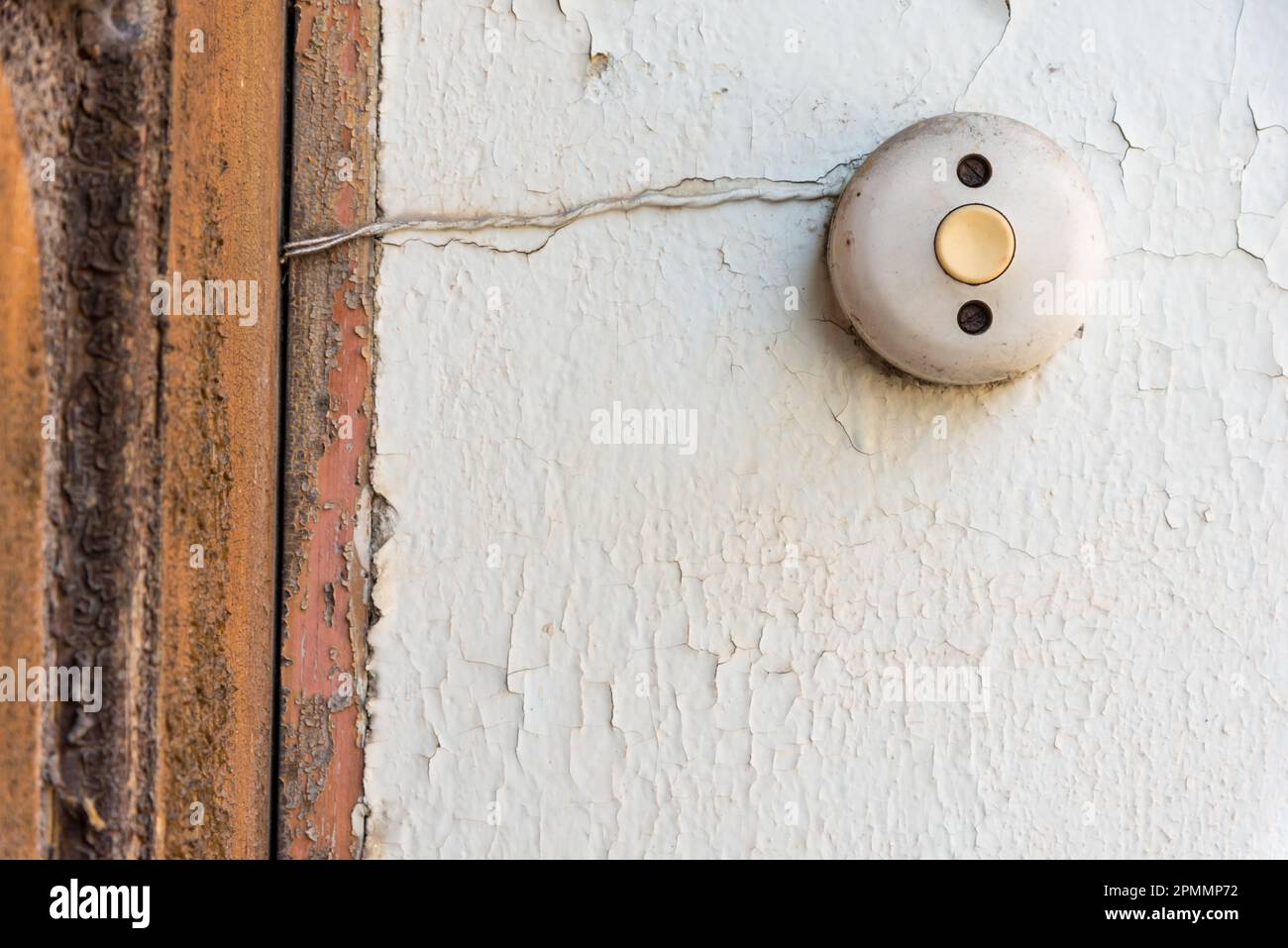 An old bell button on a white crumbling facade Stock Photo - Alamy