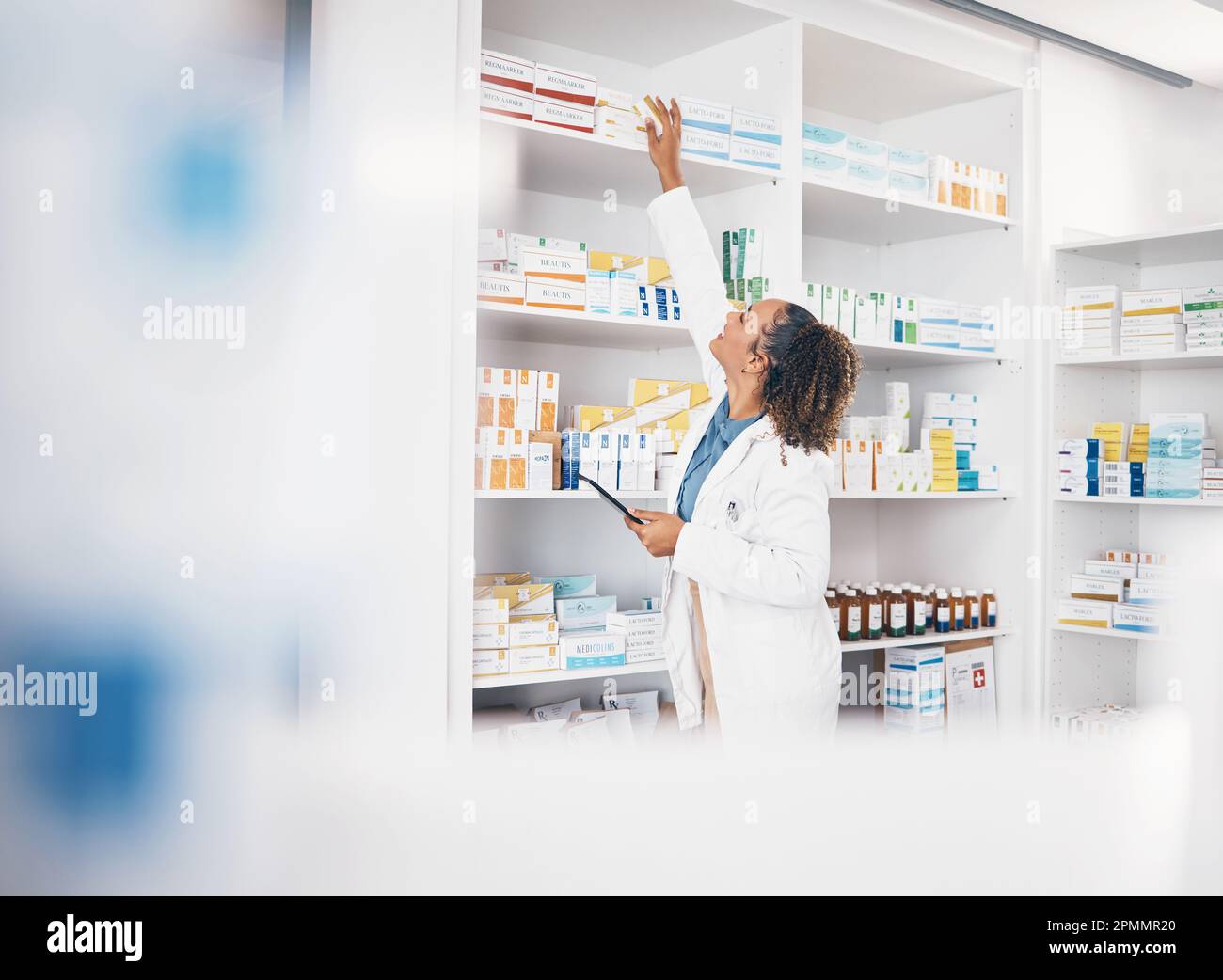Tablet, pharmacy or woman by shelf with medicine pills or supplements ...